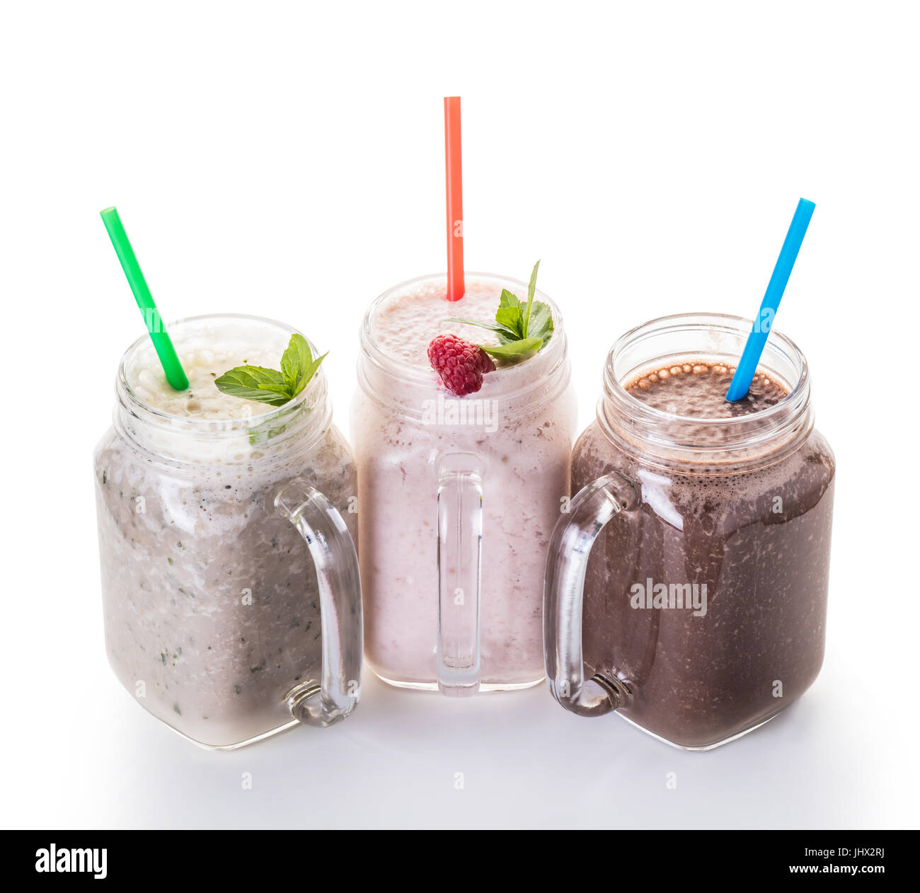 Milkshake in jar with a straw on white background Stock Photo - Alamy