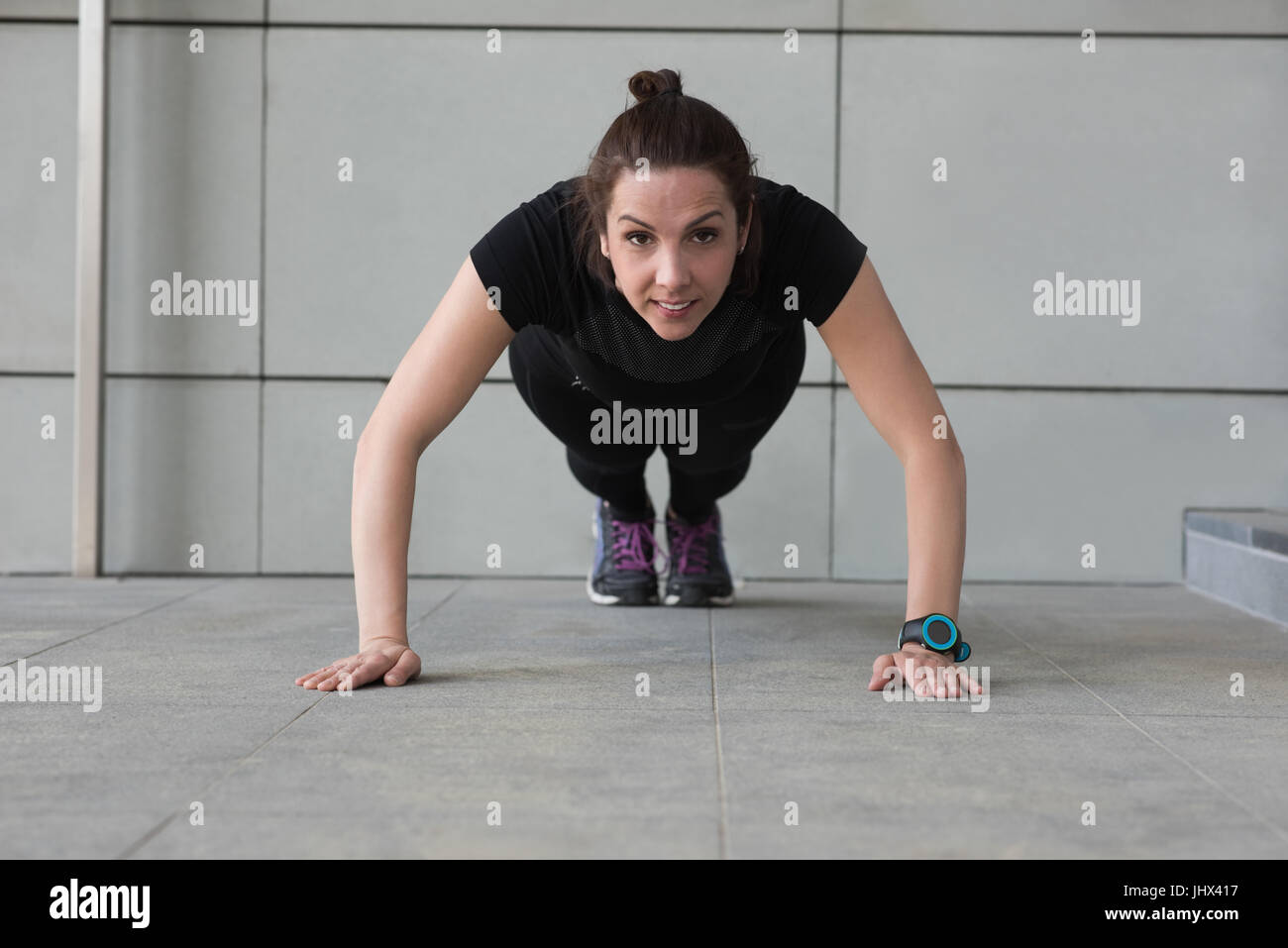 Portrait of fit woman doing pushups on staircase Stock Photo - Alamy