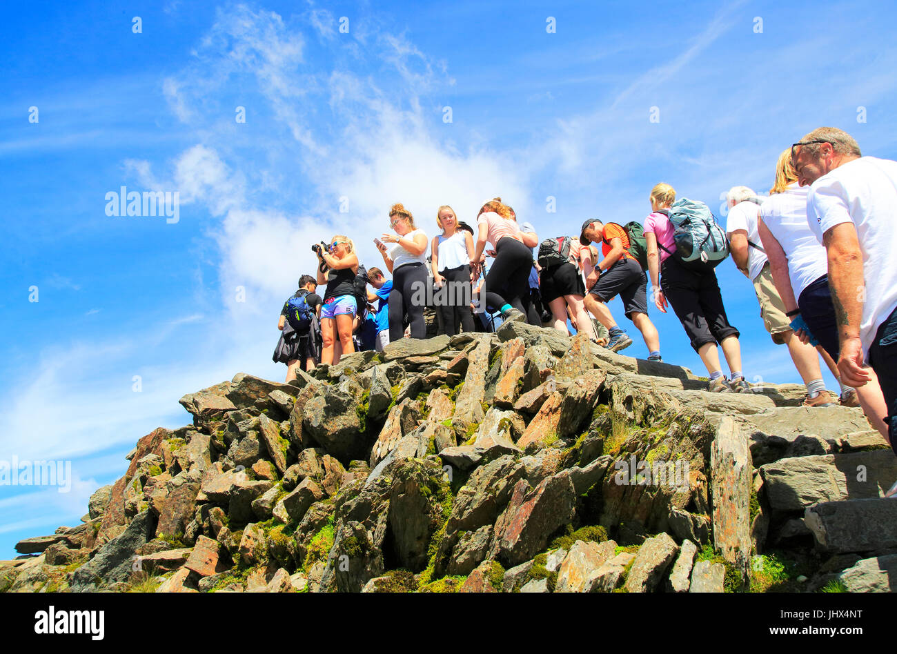 Walkers crowd onto the summit point, Mount Snowdon, Gwynedd, Snowdonia ...