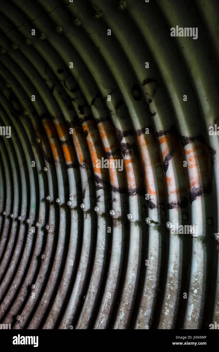 A path disappearing into an old tunnel with graffiti on the walls to a ...
