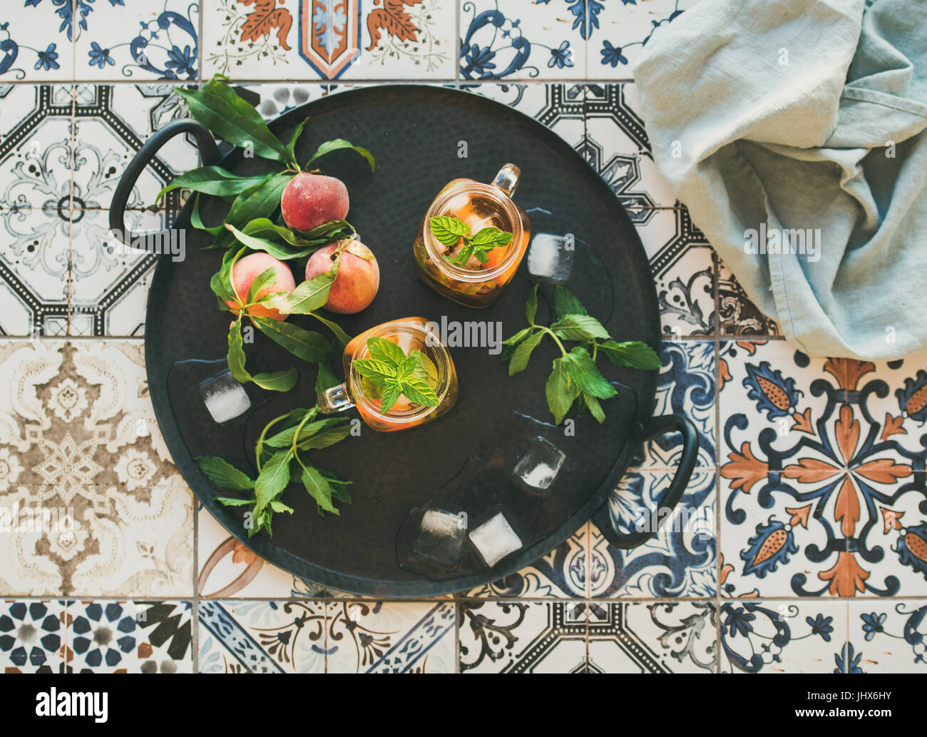 Summer refreshing cold peach ice tea in jars on tray Stock Photo - Alamy