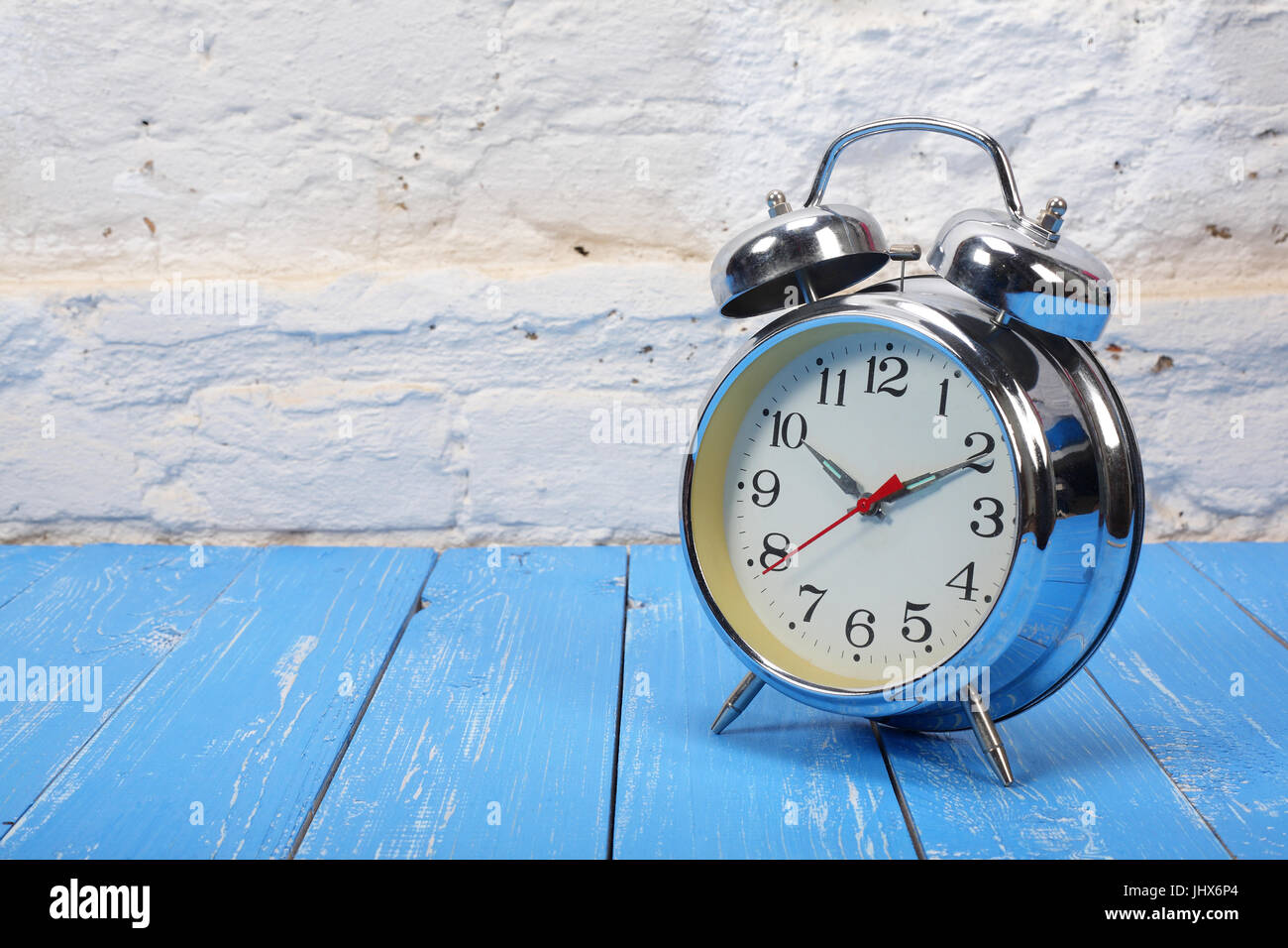 Vintage Alarm Clock - Old retro alarm clock on a blue wooden plank and ...