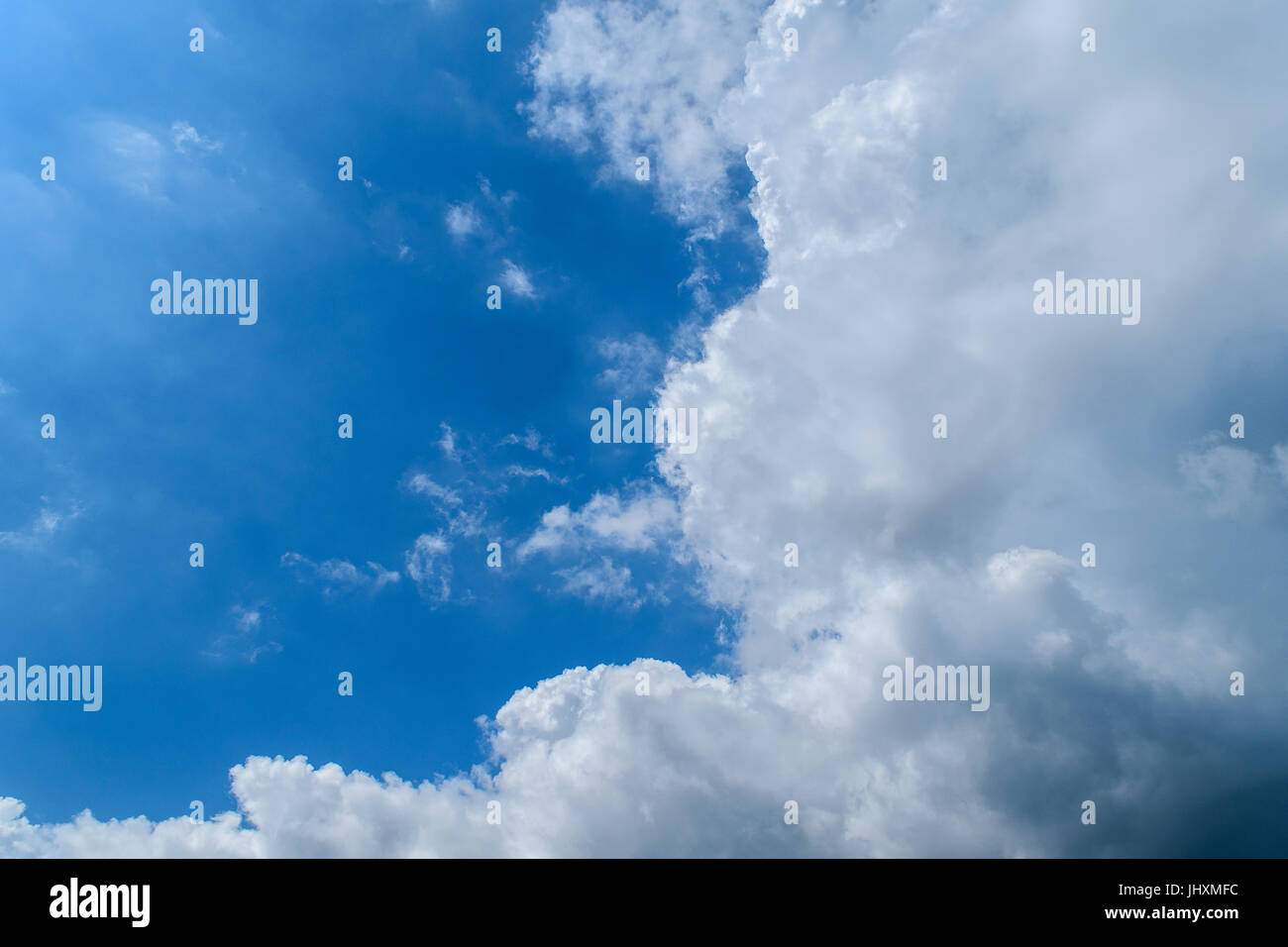 Blue sky with fluffy white clouds Stock Photo - Alamy