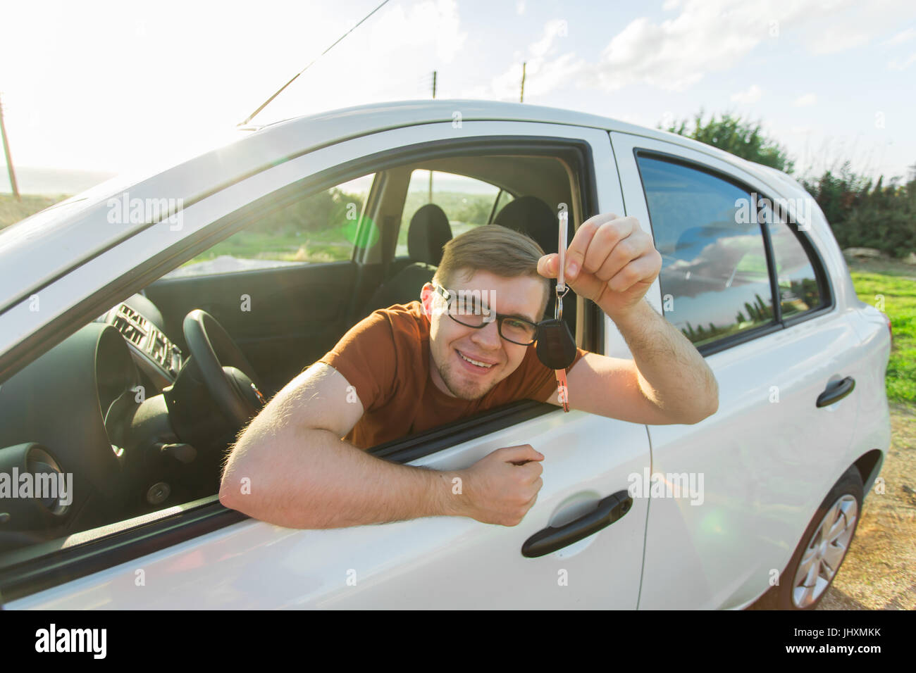 Happy man showing the key of his new car Stock Photo - Alamy