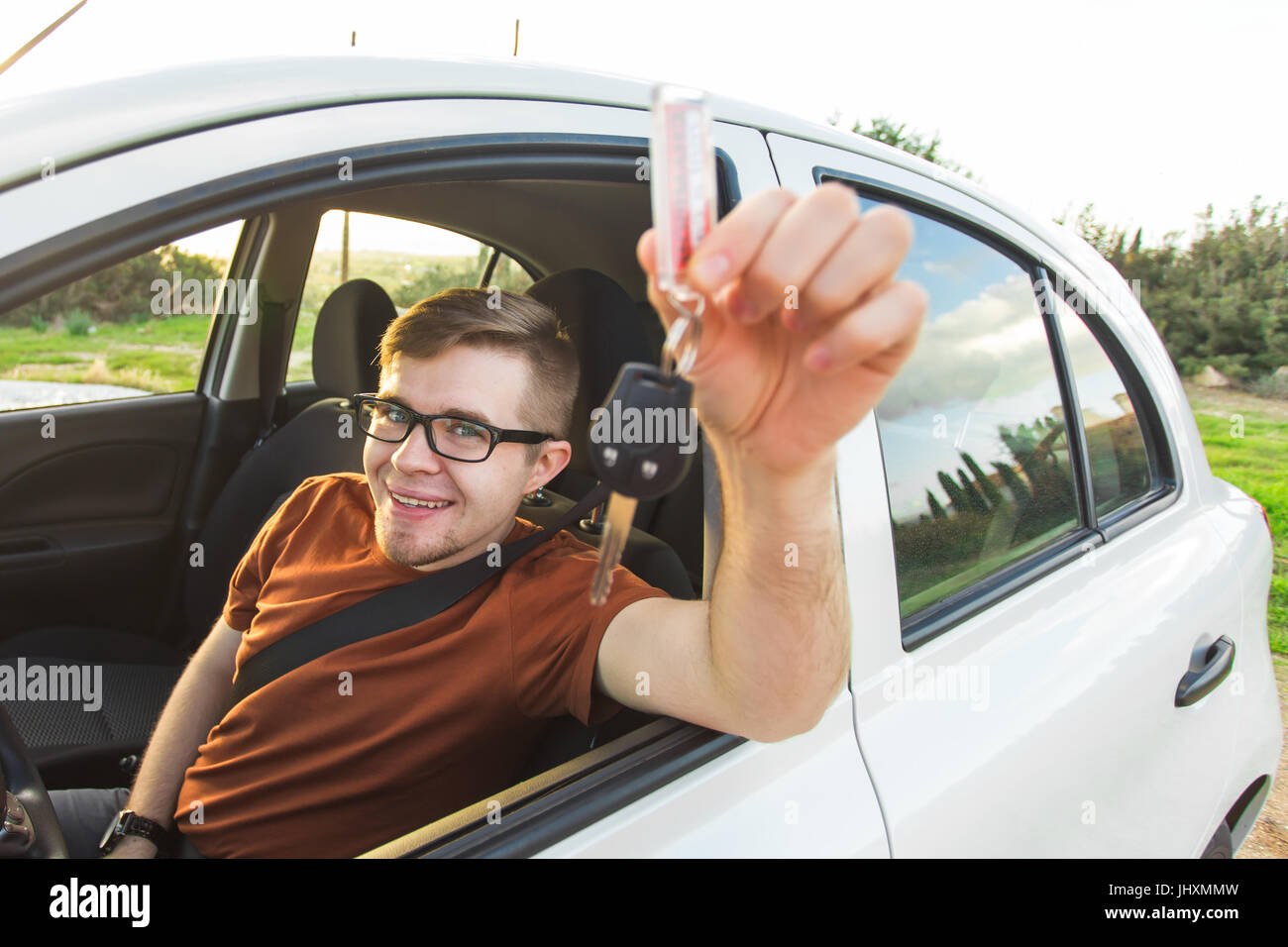 Happy man showing the key of his new car Stock Photo - Alamy