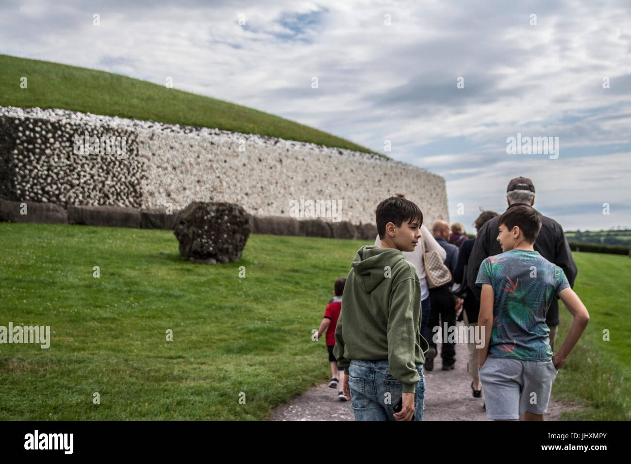 Group of People walking towards Newgrange neolithic stone age passage ...