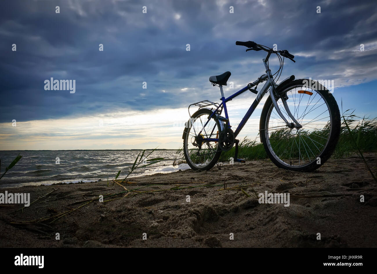 Traveling by bicycle. Beautiful scenery with a bicycle. Sunset on the ...