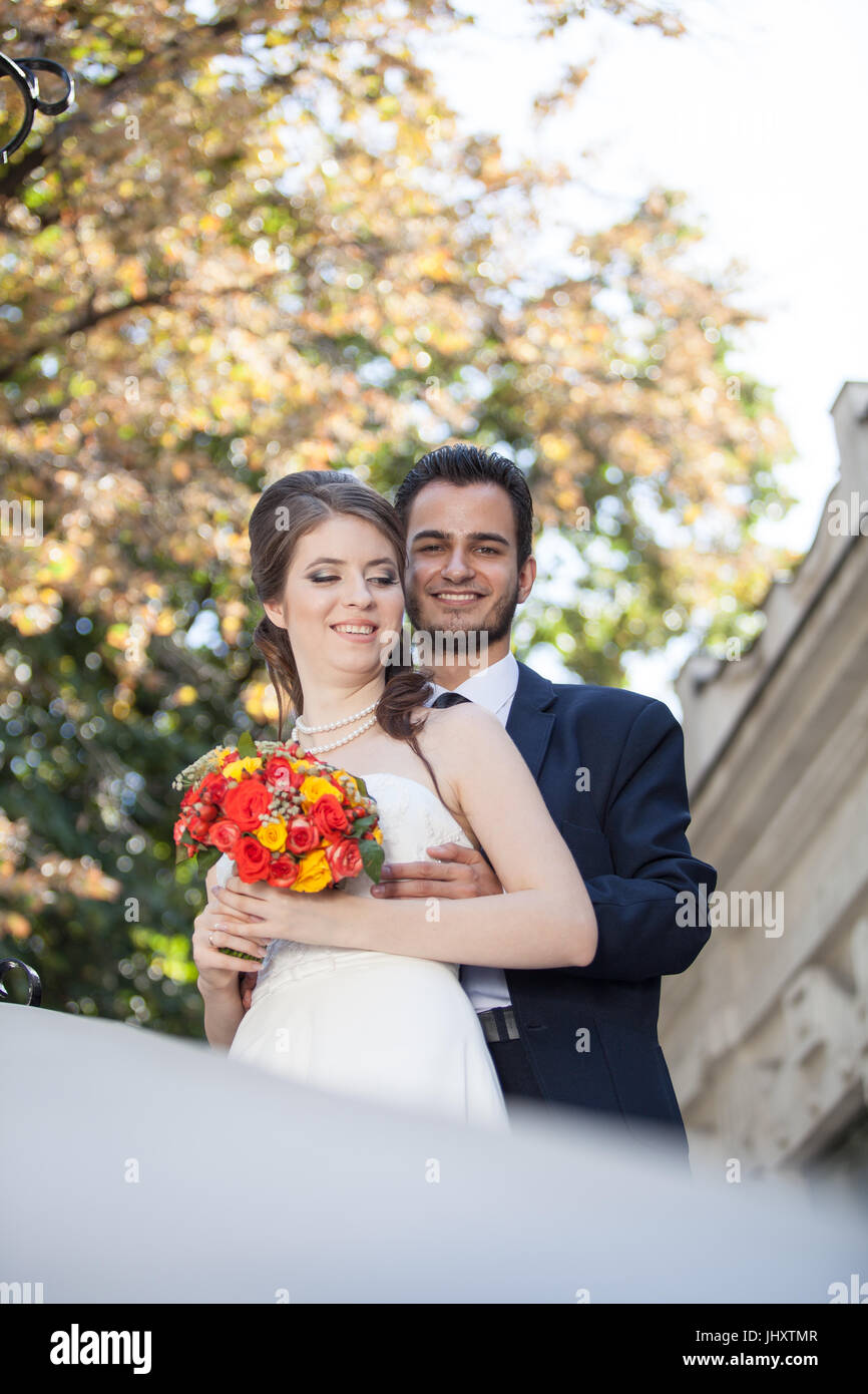 Just married young husband and wife posing in wedding photo Stock Photo ...
