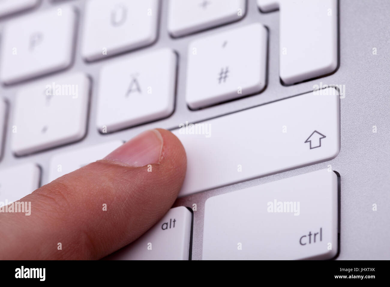 Finger pressing on keyboard Stock Photo - Alamy