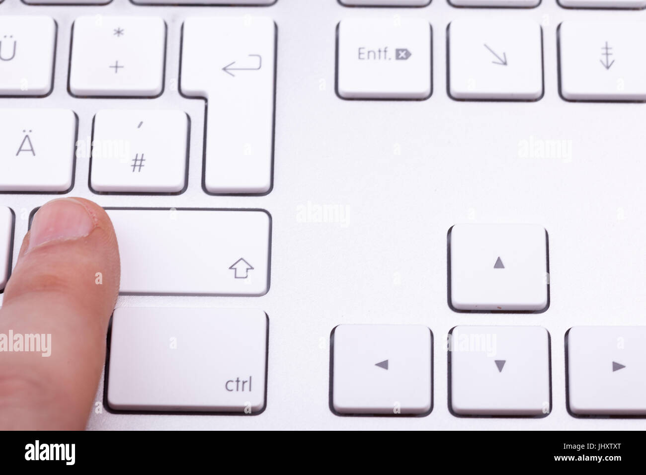 Finger pressing on keyboard Stock Photo - Alamy