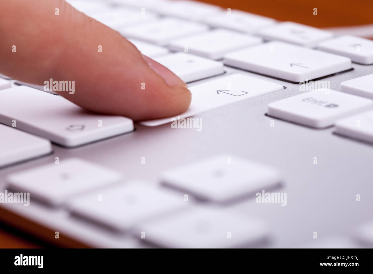 Finger pressing on keyboard Stock Photo - Alamy
