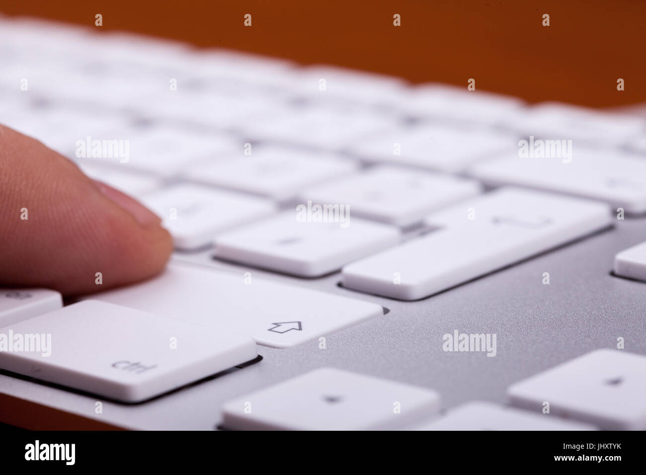 Finger pressing on keyboard Stock Photo - Alamy