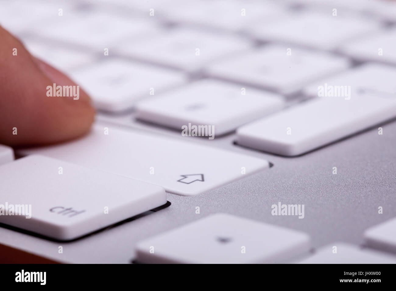 Finger pressing on keyboard Stock Photo - Alamy