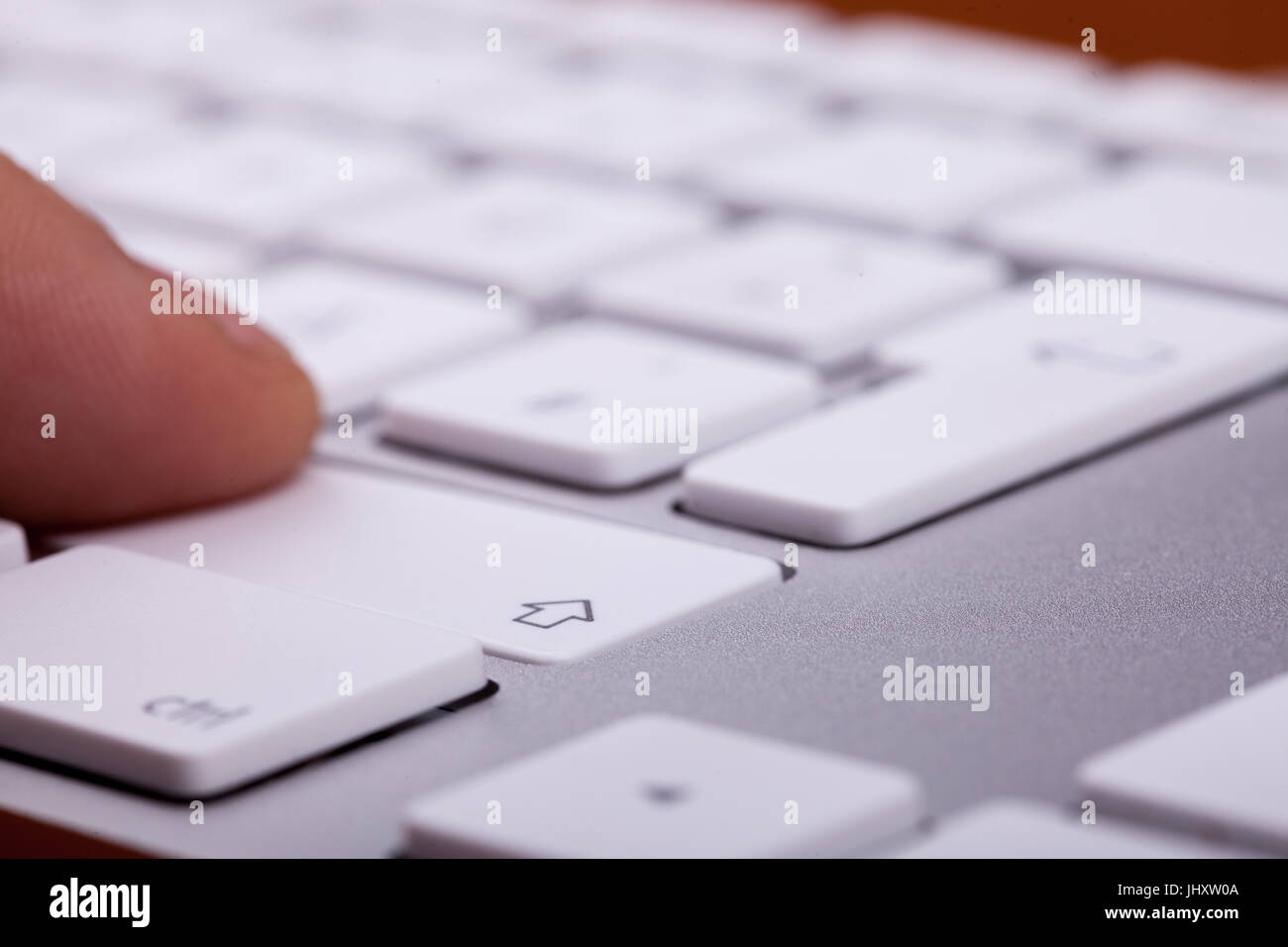 Finger pressing on keyboard Stock Photo - Alamy