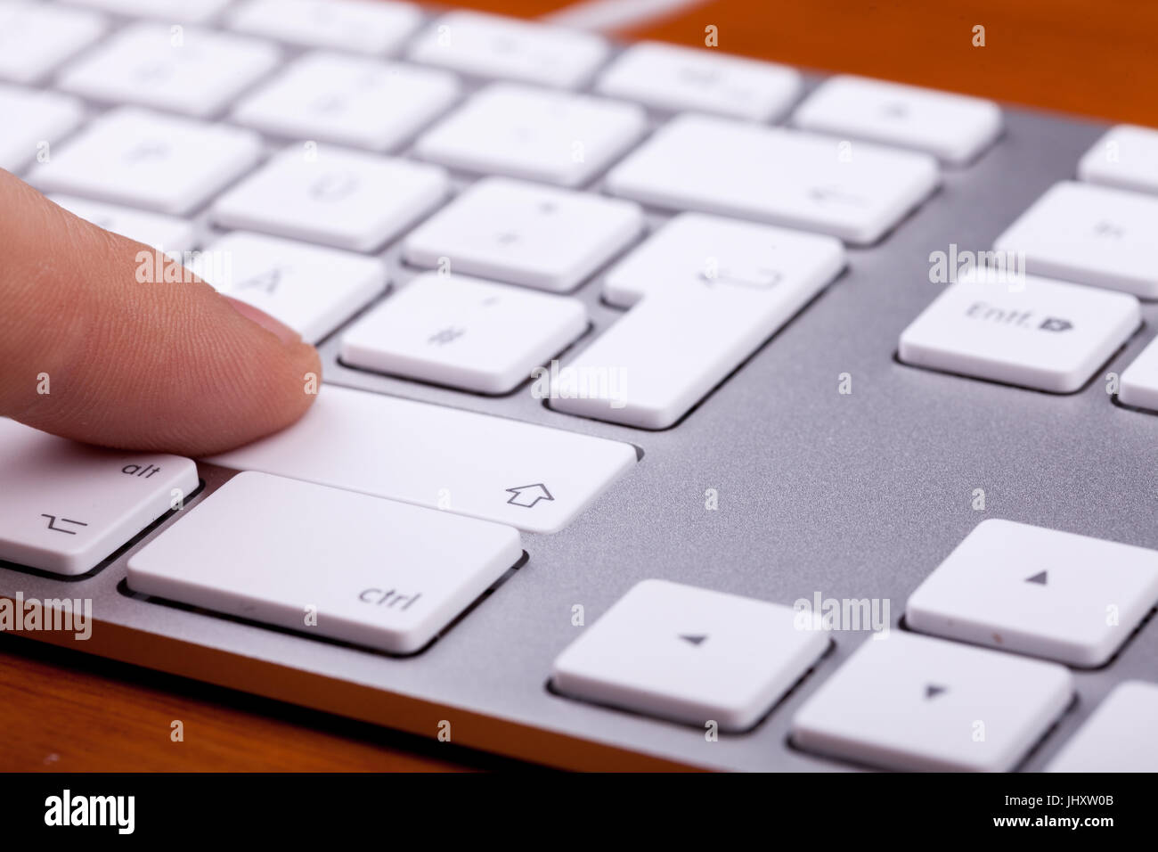 Finger pressing on keyboard Stock Photo - Alamy