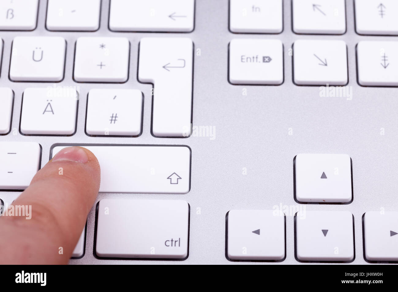 Finger pressing on keyboard Stock Photo - Alamy