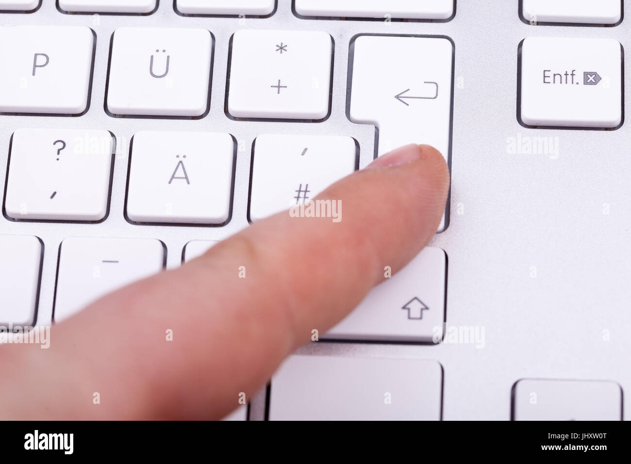 Finger pressing on keyboard Stock Photo - Alamy