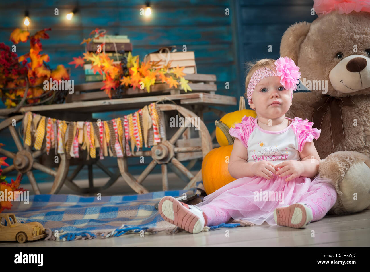 Happy one year old baby girl in autumn interior Stock Photo - Alamy