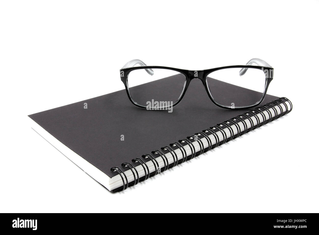 Notebook and glasses on white background Stock Photo - Alamy