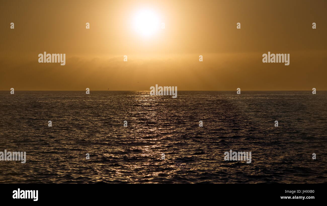 sunset over ocean Stock Photo - Alamy