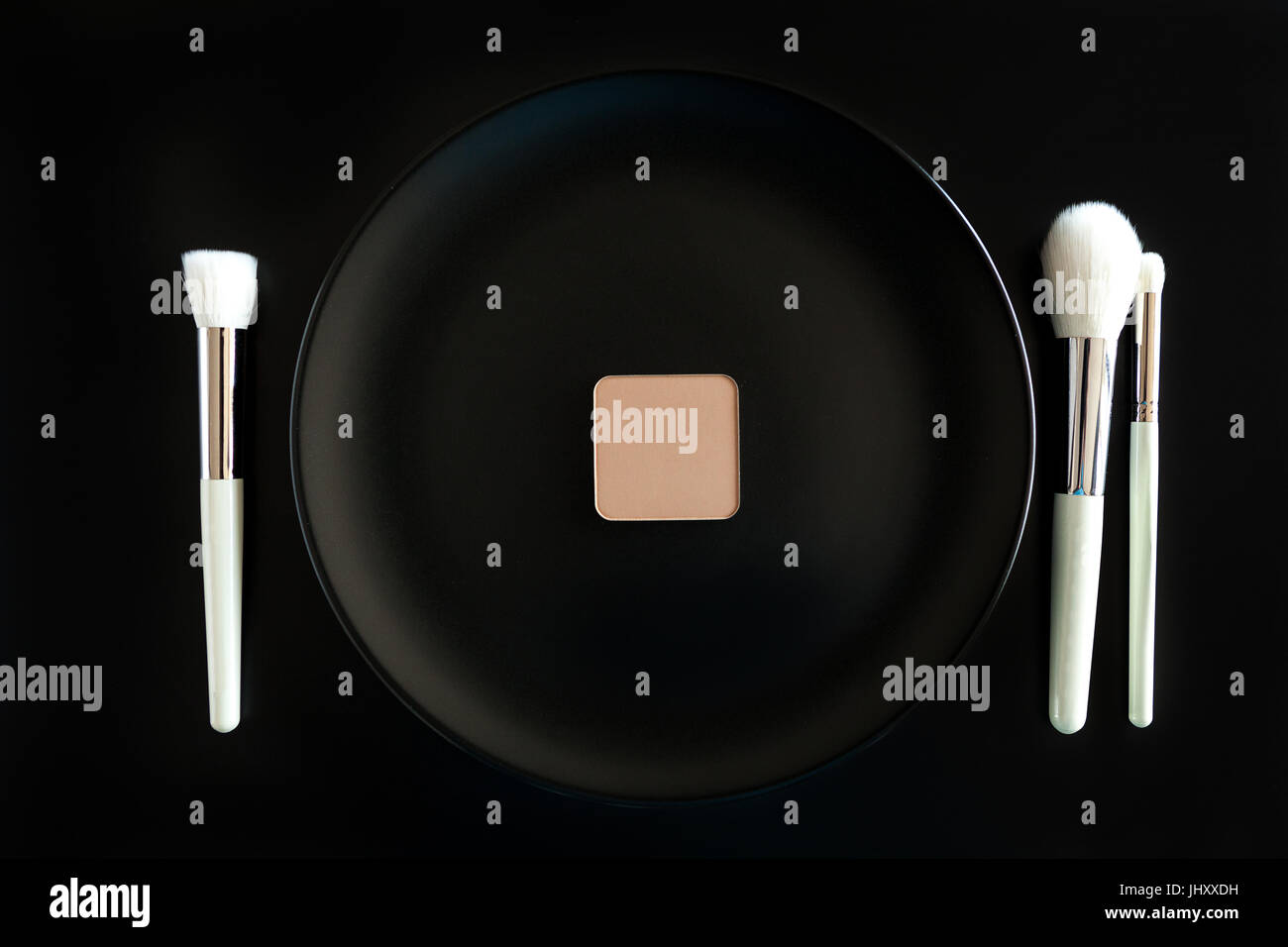 Conceptual image of make up brushes next to dinner plate Stock Photo ...