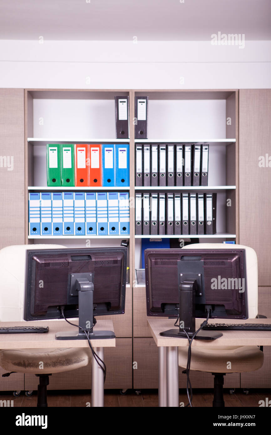 Empty office room with computers and desks Stock Photo - Alamy
