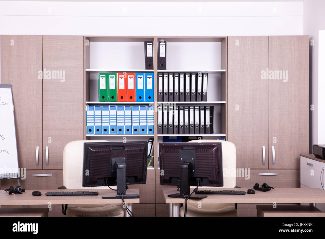 Empty office room with computers and desks Stock Photo - Alamy