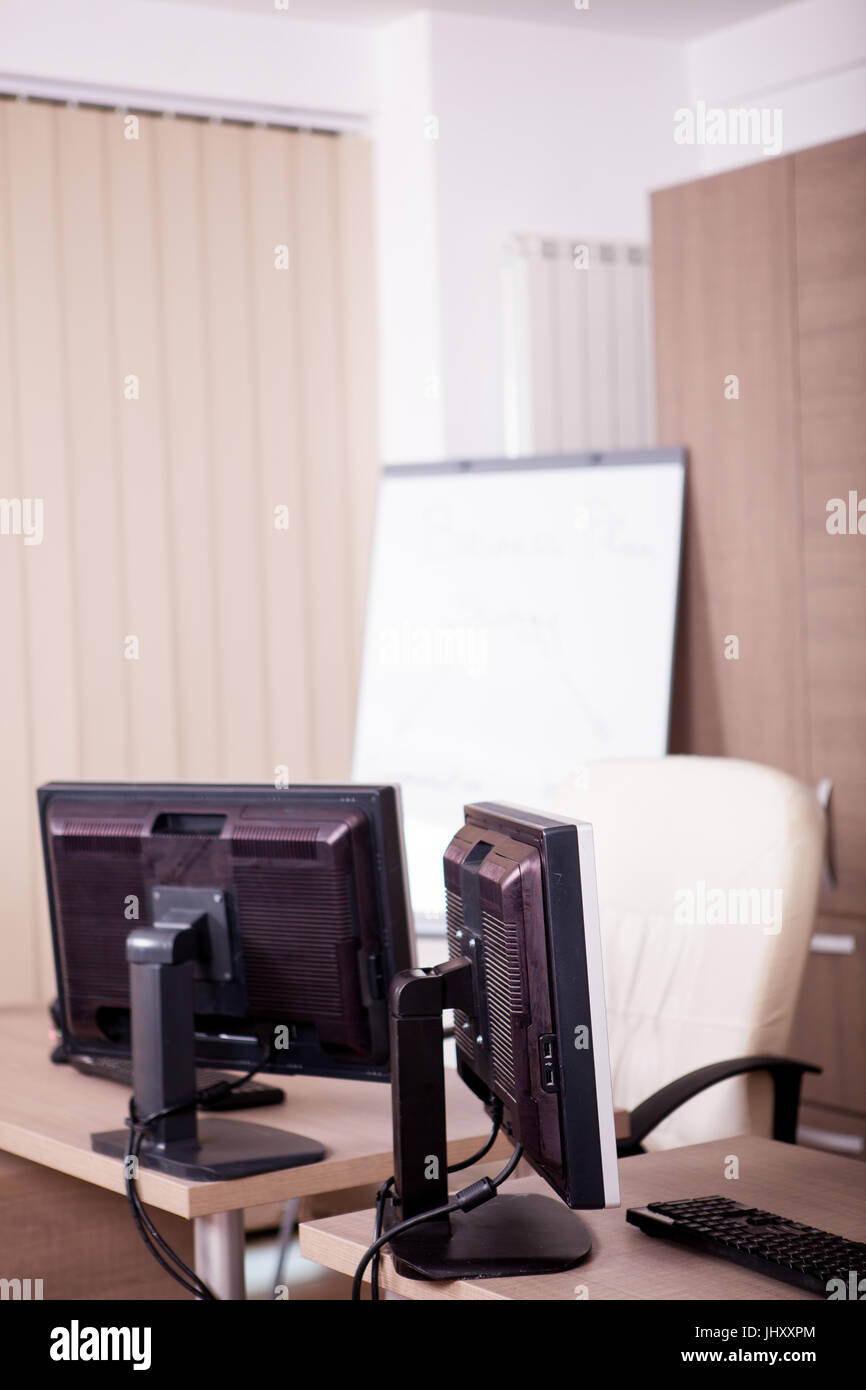 Empty office room with computers and desks Stock Photo - Alamy
