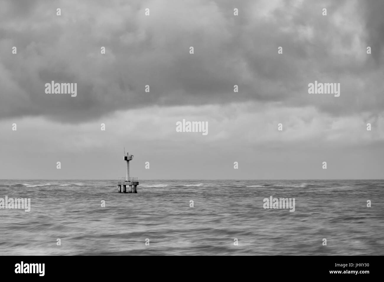 lighthouse with black clouds in the rainy day. Black and White Stock ...