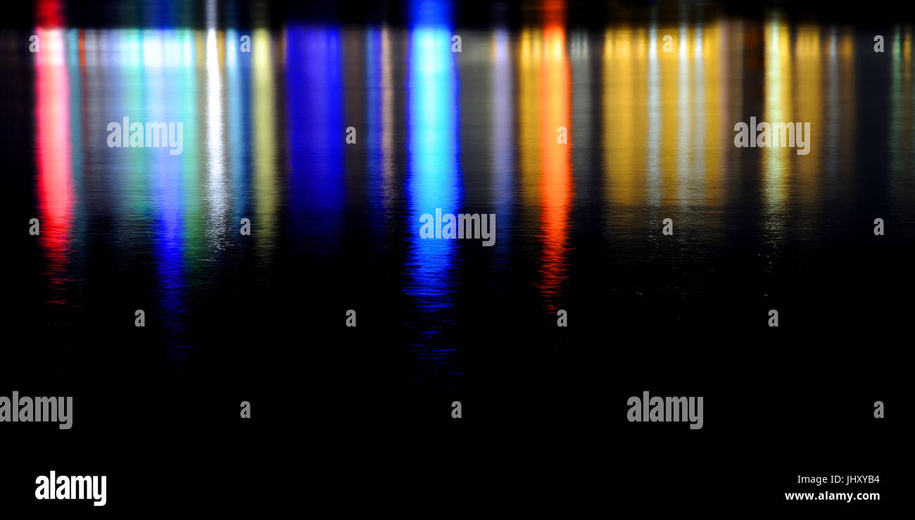 Colorful night city lighting reflection in sea water Stock Photo - Alamy