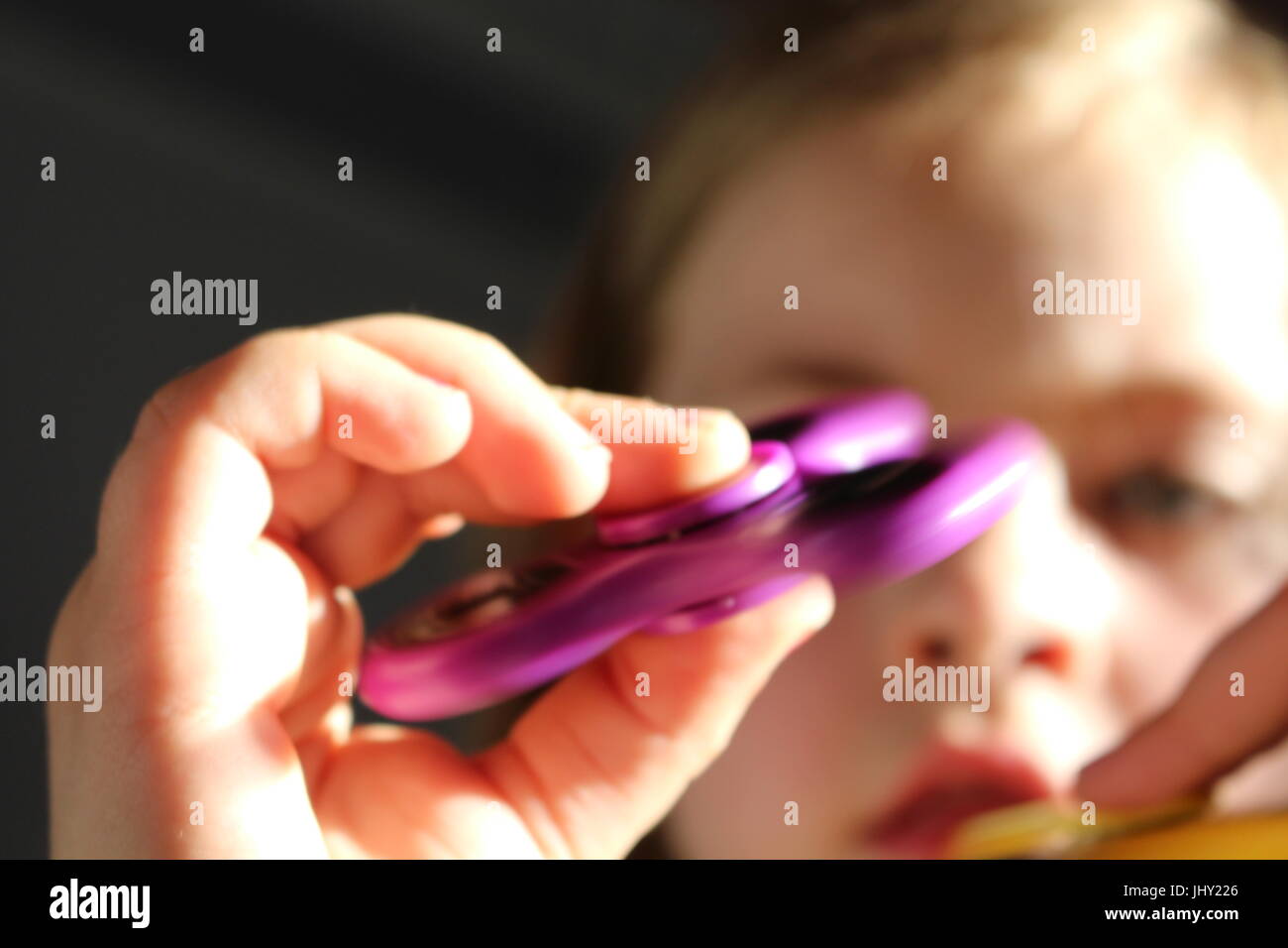 child spinning fidget spinner, fidget spinner, child with fidget ...