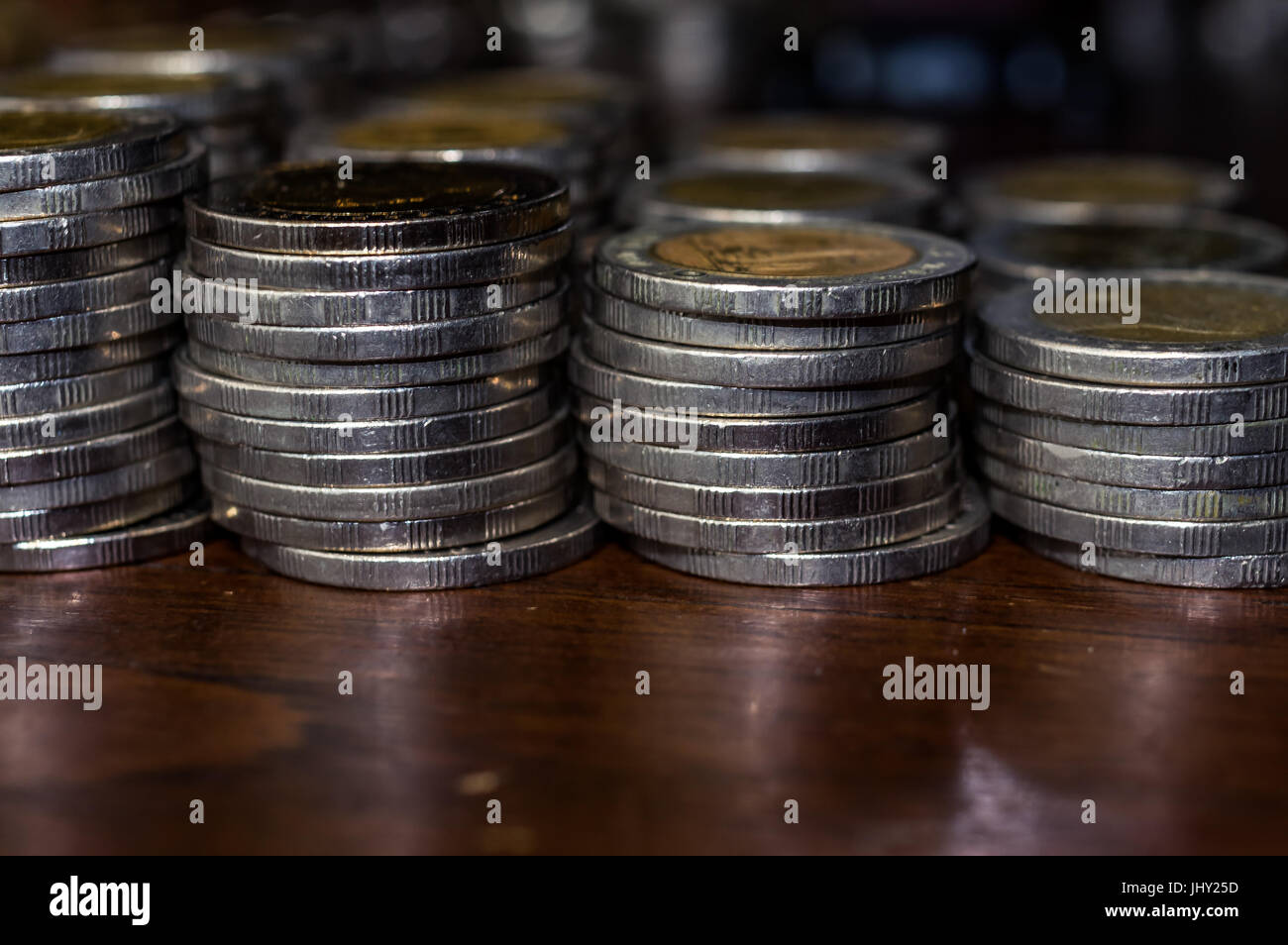 stacks of coins, small change on wooden table surface Stock Photo - Alamy