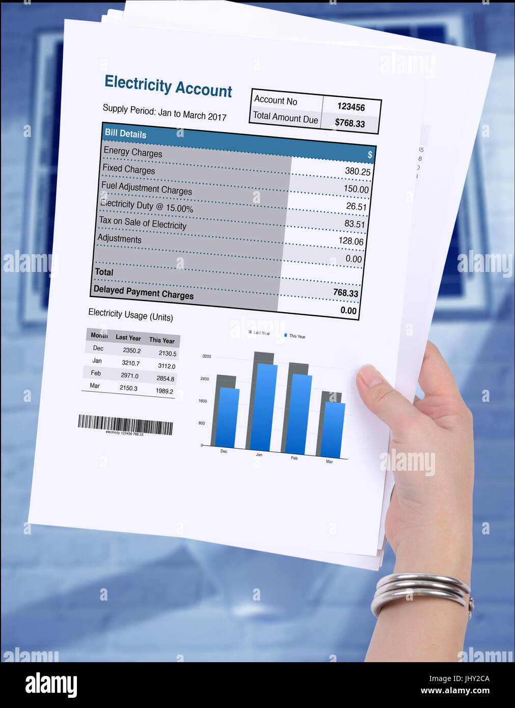 Electricity account bill in someone hand on blue background Stock Photo ...