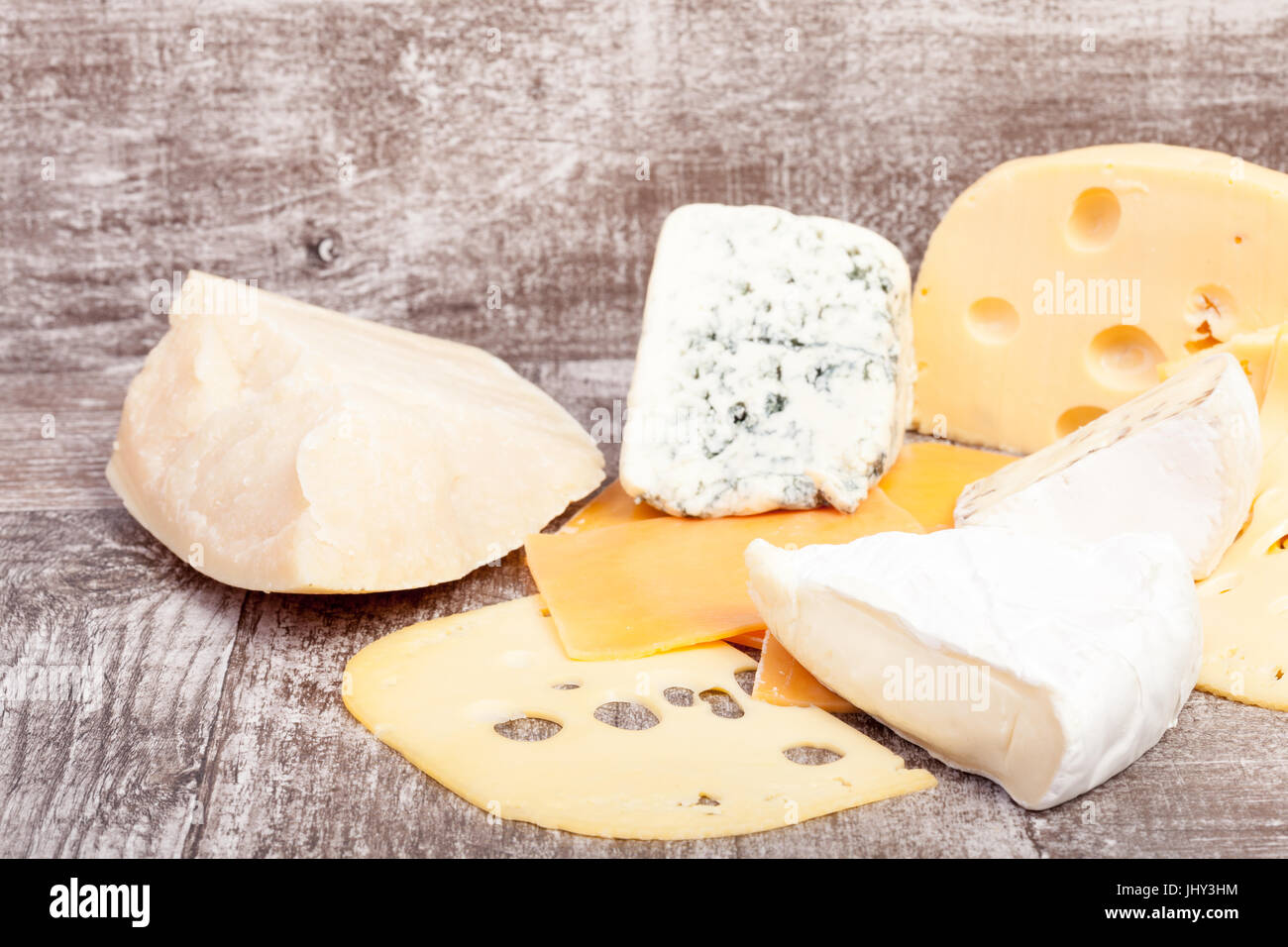 Different type of cheese on wooden background Stock Photo - Alamy