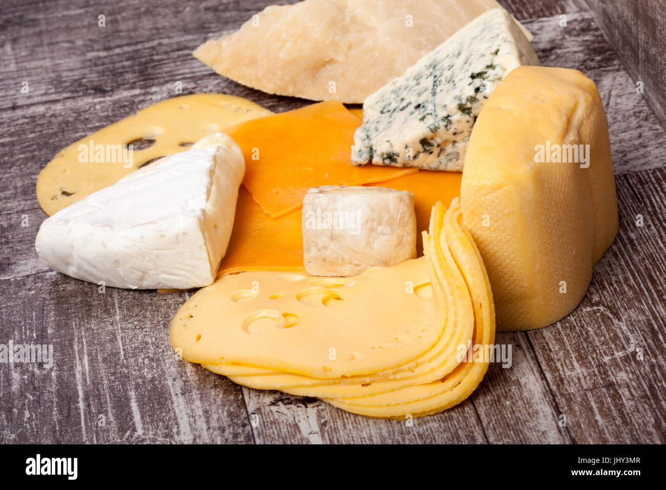 Different type of cheese on wooden background Stock Photo - Alamy