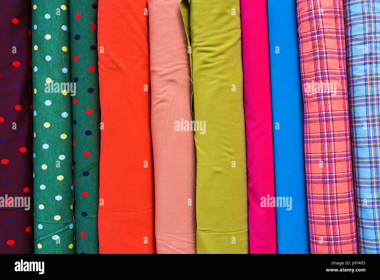 Multi color fabric in a row Stock Photo - Alamy
