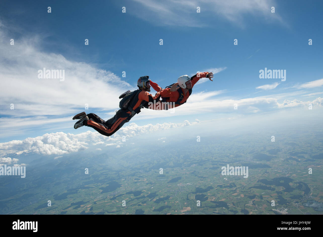An skydiving instructor is taking a student on a training jump during ...