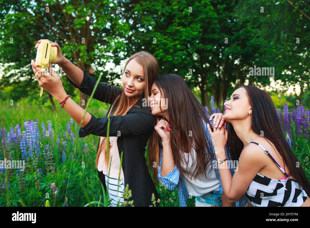 Three hipsters girls blonde and brunette taking self portrait on ...
