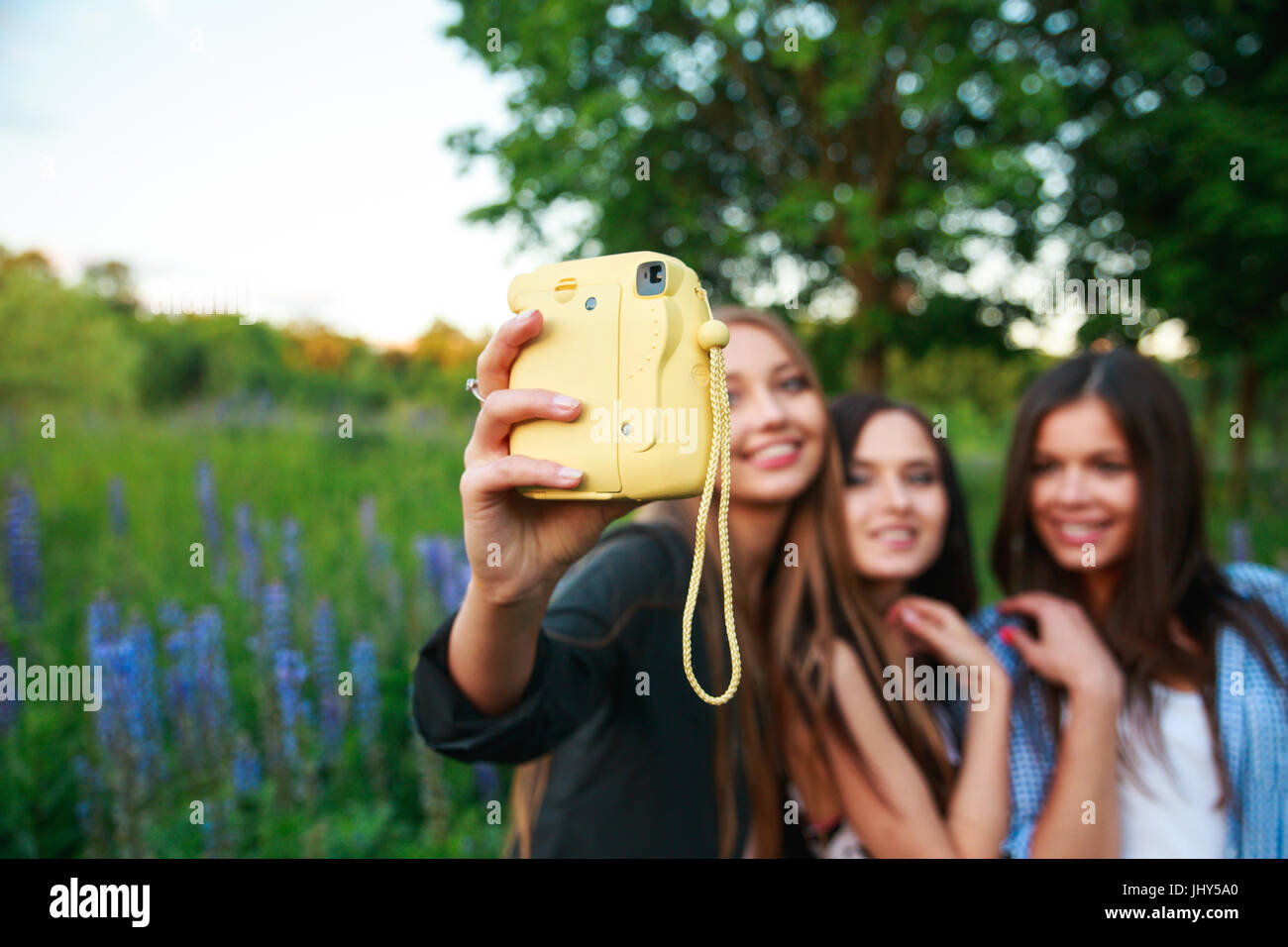 Three hipsters girls blonde and brunette taking self portrait on ...