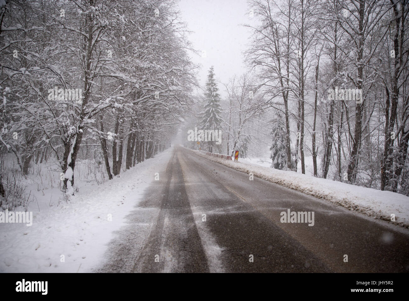 Icy road in a winter day in Moldava region, Romania Stock Photo - Alamy