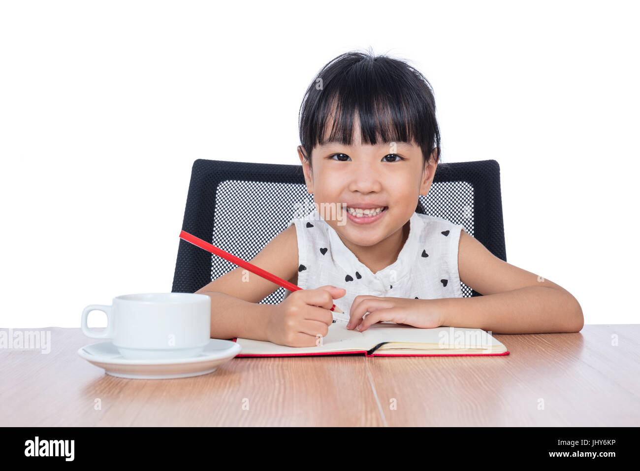 Asian Chinese little girl doing homework in isolated white background ...