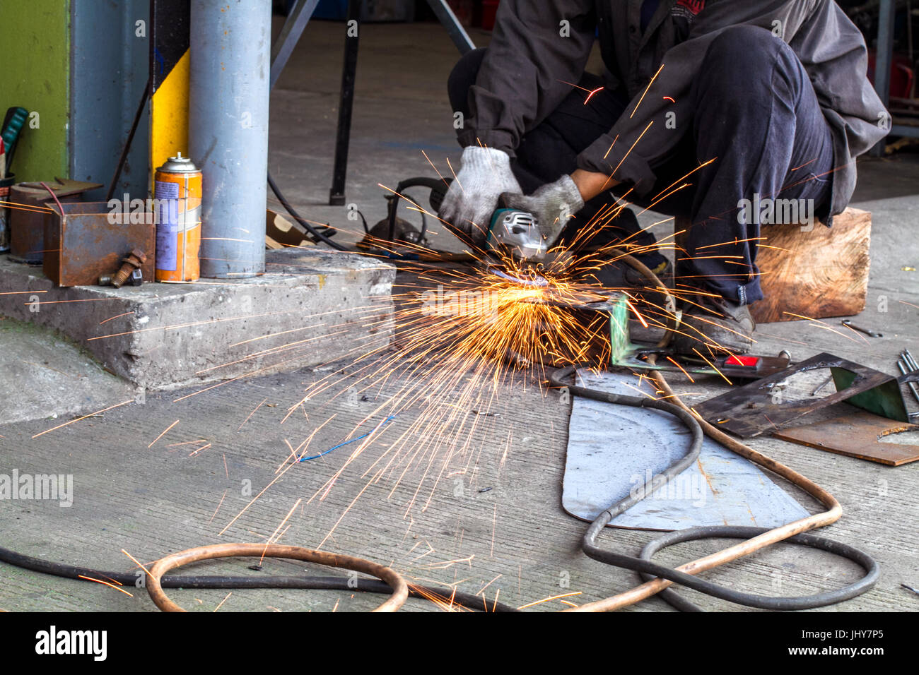 A person angle grinding on metal Stock Photo - Alamy