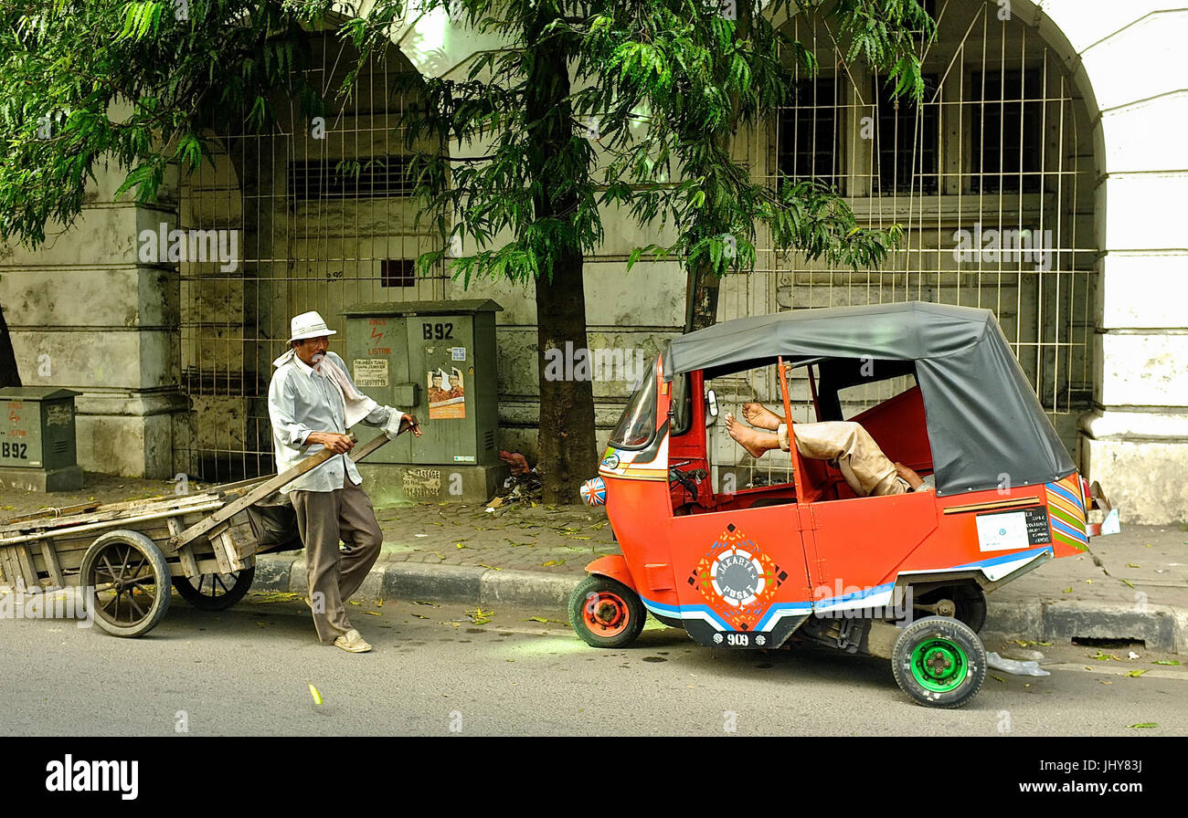 An Ojek driver sleeps in his vehicle Jakarta, Indonesia Stock Photo - Alamy