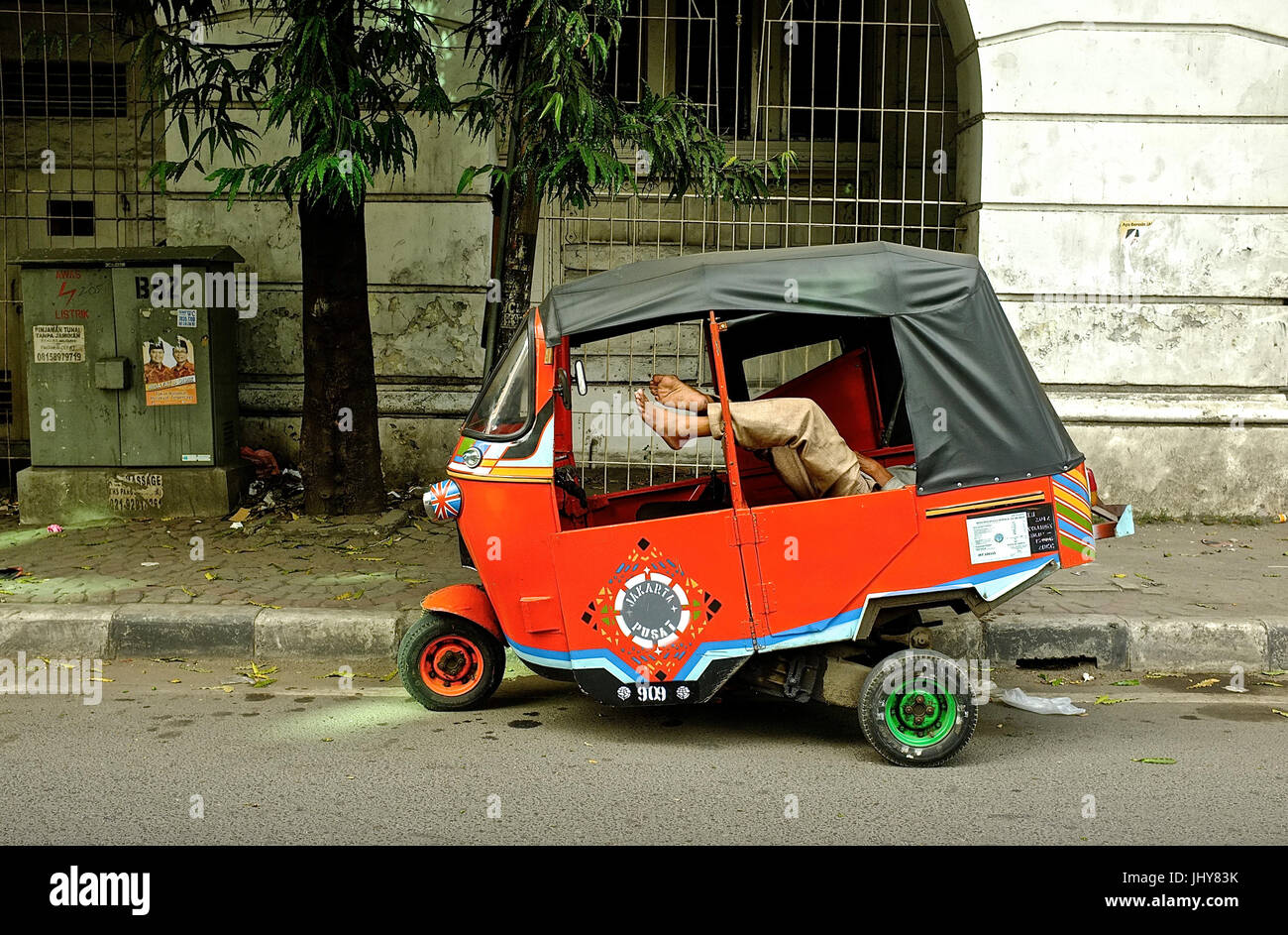 An Ojek driver sleeps in his vehicle in Jakarta, Indonesia Stock Photo ...