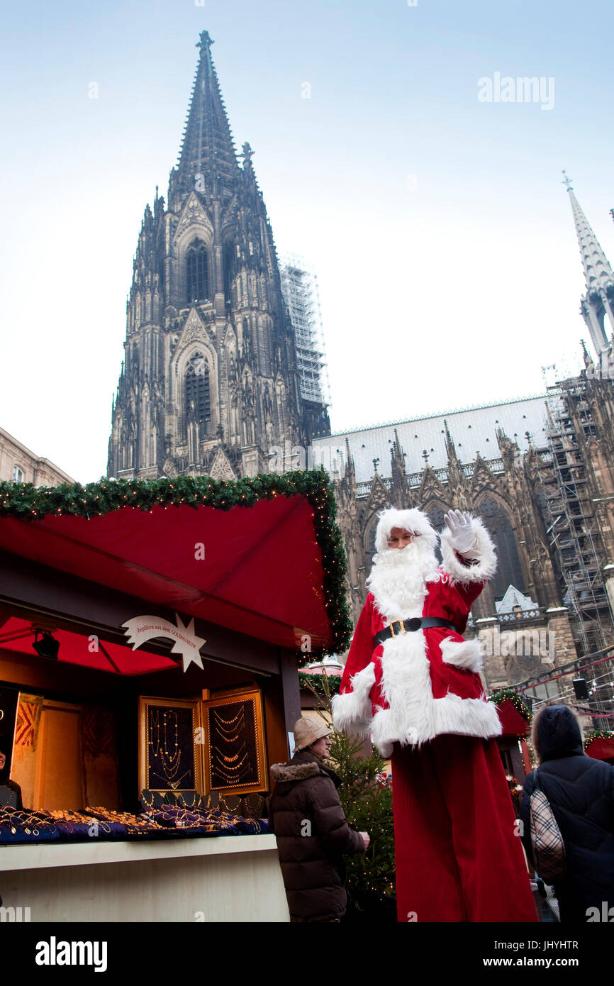 Europe, Germany, Cologne, Santa Claus on stilts at the Christmas market ...