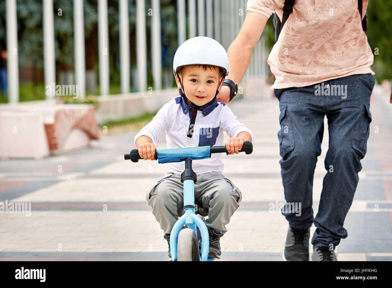 First lessons bicycle riding. Father teach his son to ride a bike Stock ...