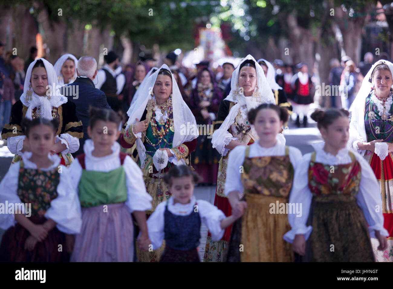 Women and children in traditional dress during the Saint Antioco parade ...