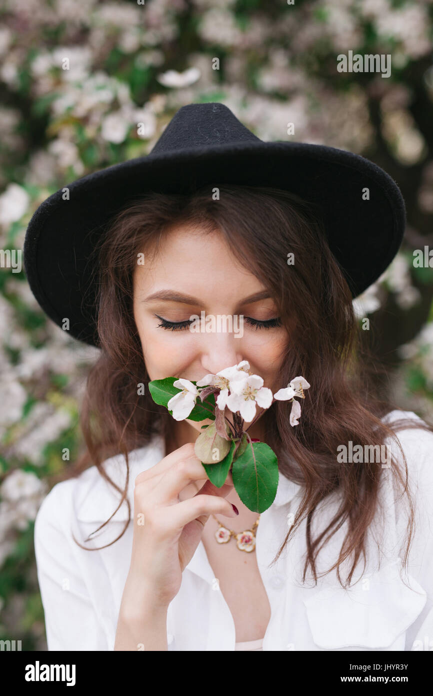 Girl sniffing cherry flowers in park at spring Stock Photo - Alamy
