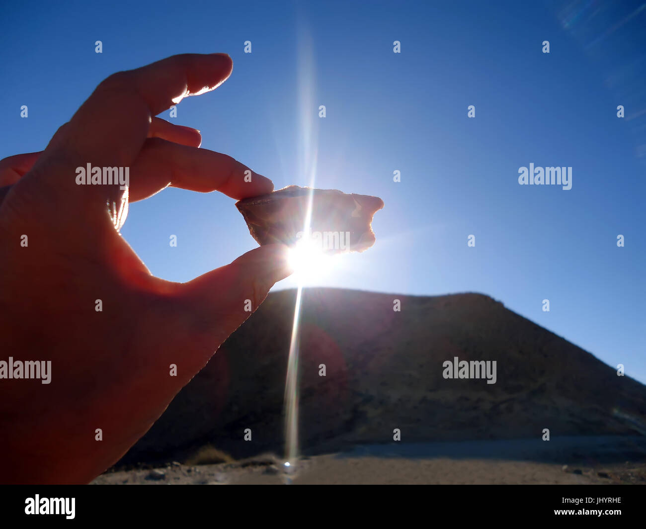 Sunlight through a stone in a woman's hand wallpaper Stock Photo - Alamy