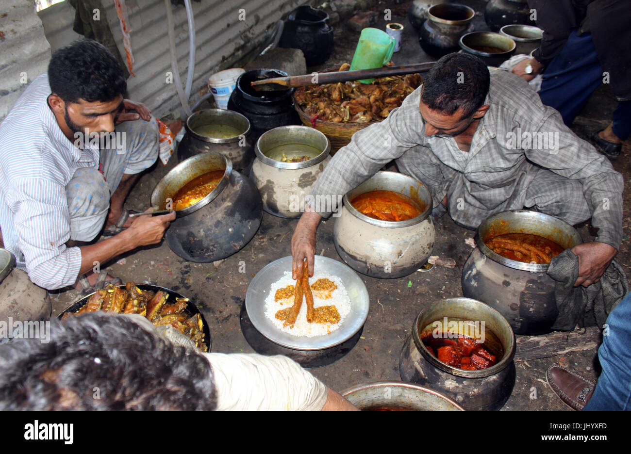 A chef is busy while distributing the items of Wazwan .Wazwan is a ...